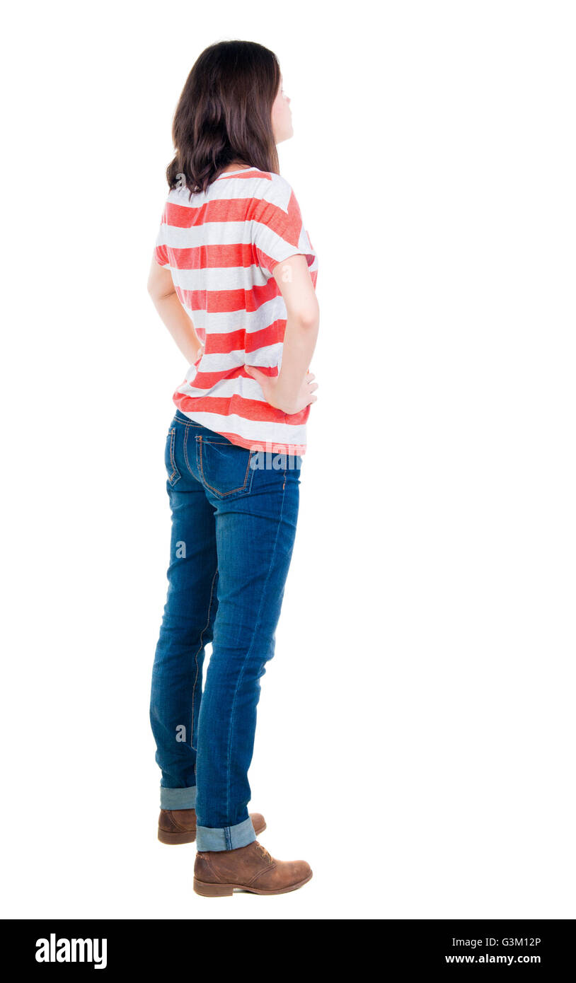 back view of standing young beautiful brunette woman in yellow pullover ...