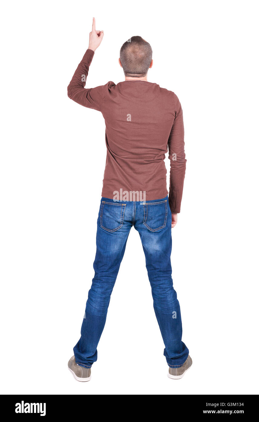 Back view of pointing young men in shirt and jeans. Young guy gesture ...
