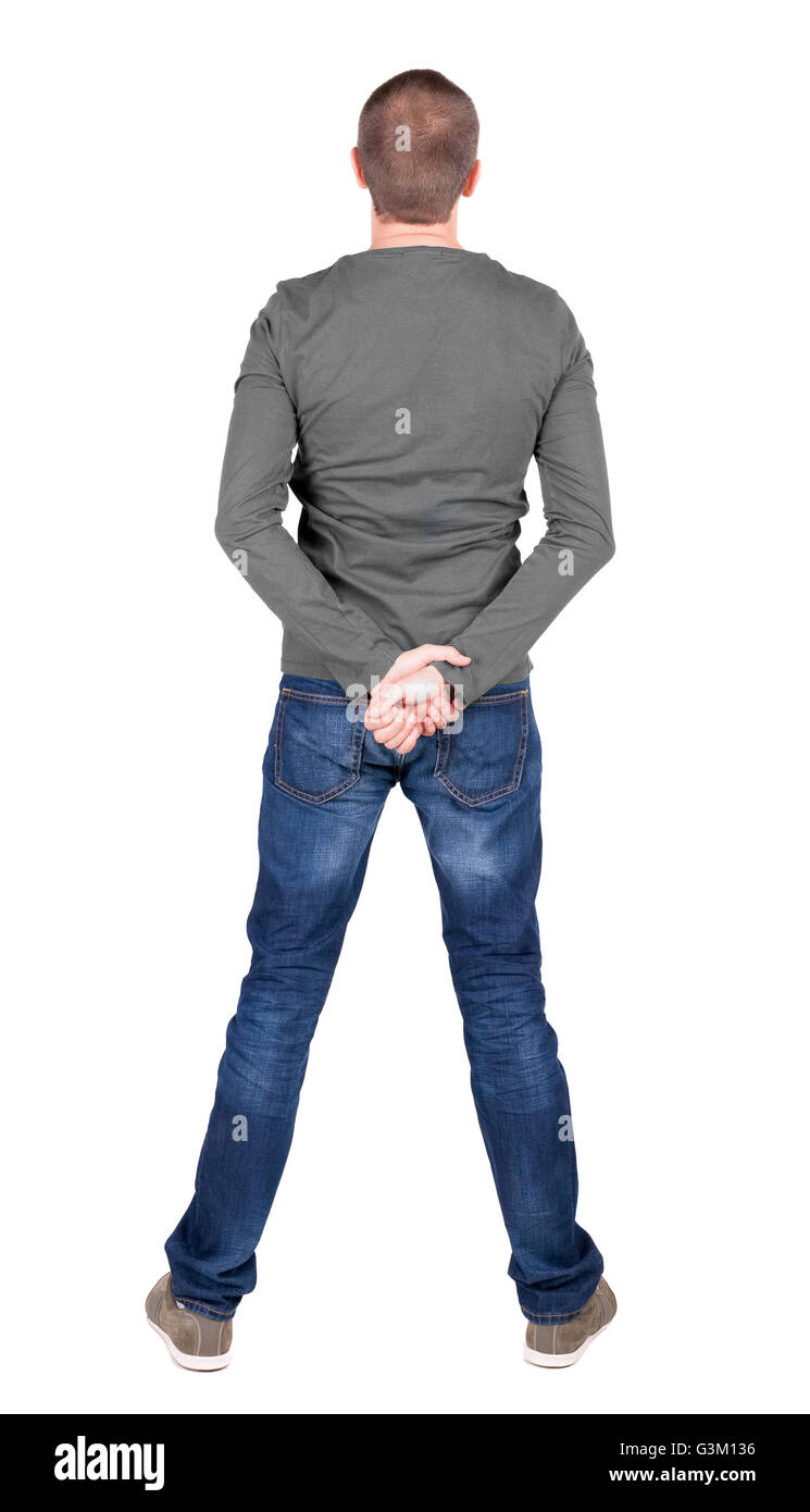 Back view of young man in t-shirt and jeans looking. Standing young guy ...