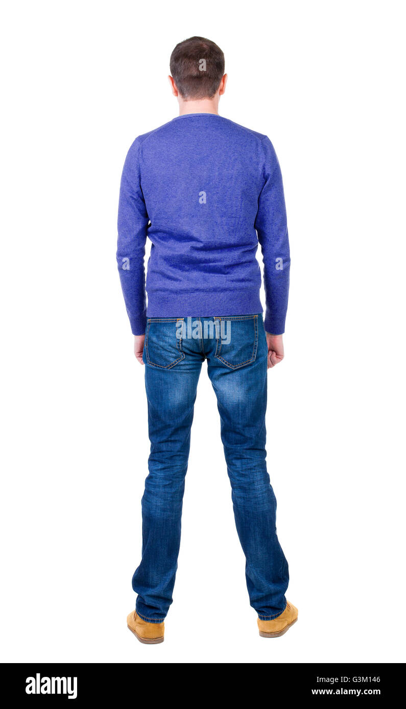 Back view of handsome man in blue pullover looking up. Standing young ...