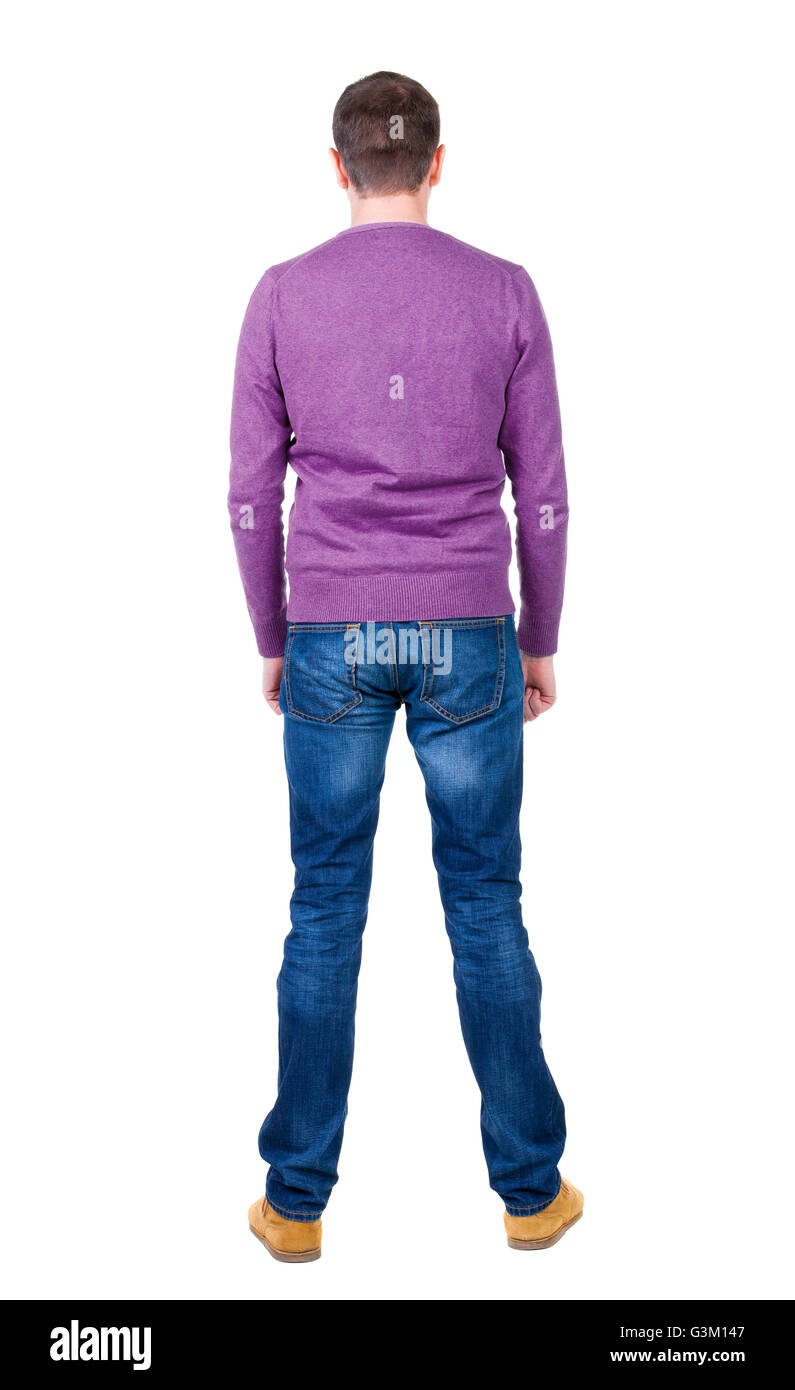 Back view of handsome man in blue pullover looking up. Standing young ...