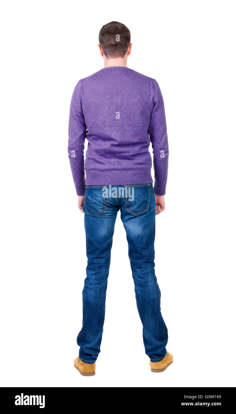 Back view of handsome man in blue pullover looking up. Standing young ...