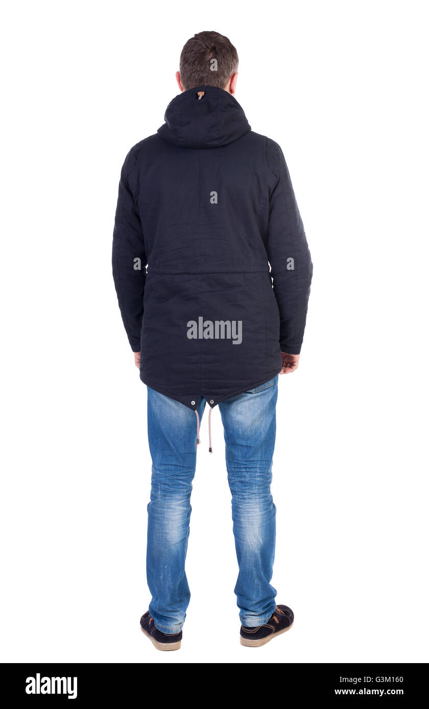 Back view of handsome man in winter jacket looking up. Standing young ...