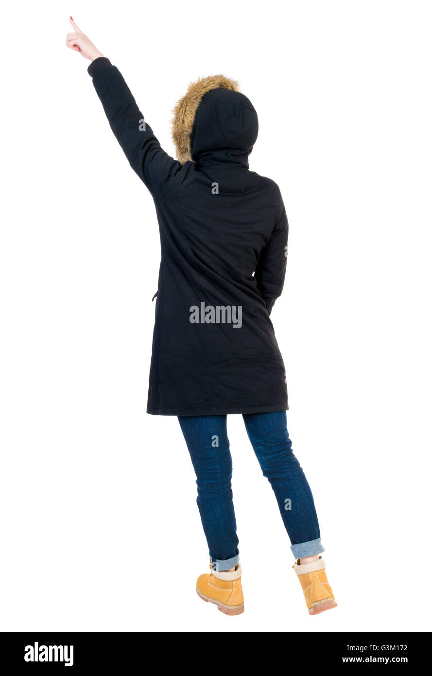 Back view of pointing young women in parka. Young girl gesture. Rear ...
