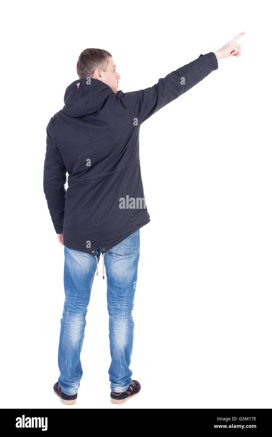 Back view of pointing young men in parka. Young guy gesture. Rear view ...