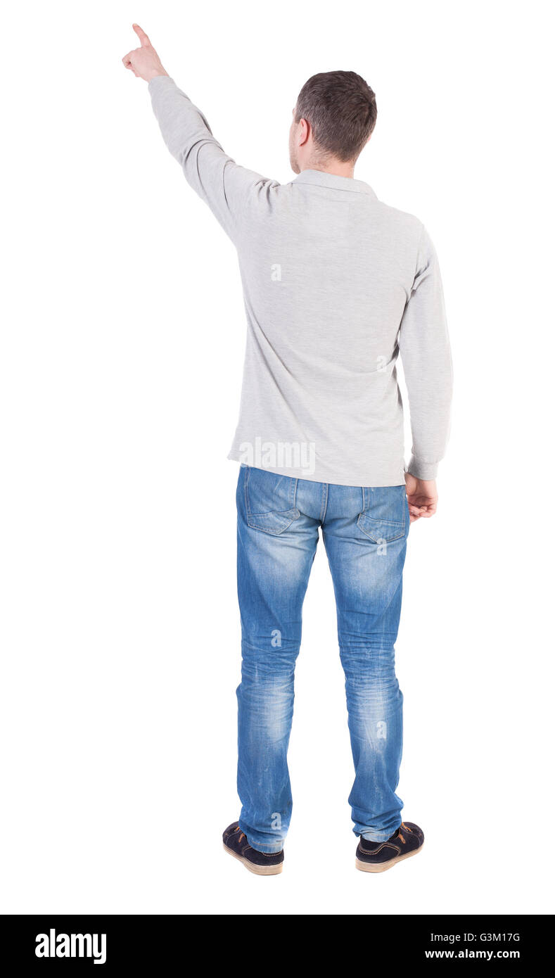 Back view of pointing young men in jeans. Young guy gesture. Rear view ...