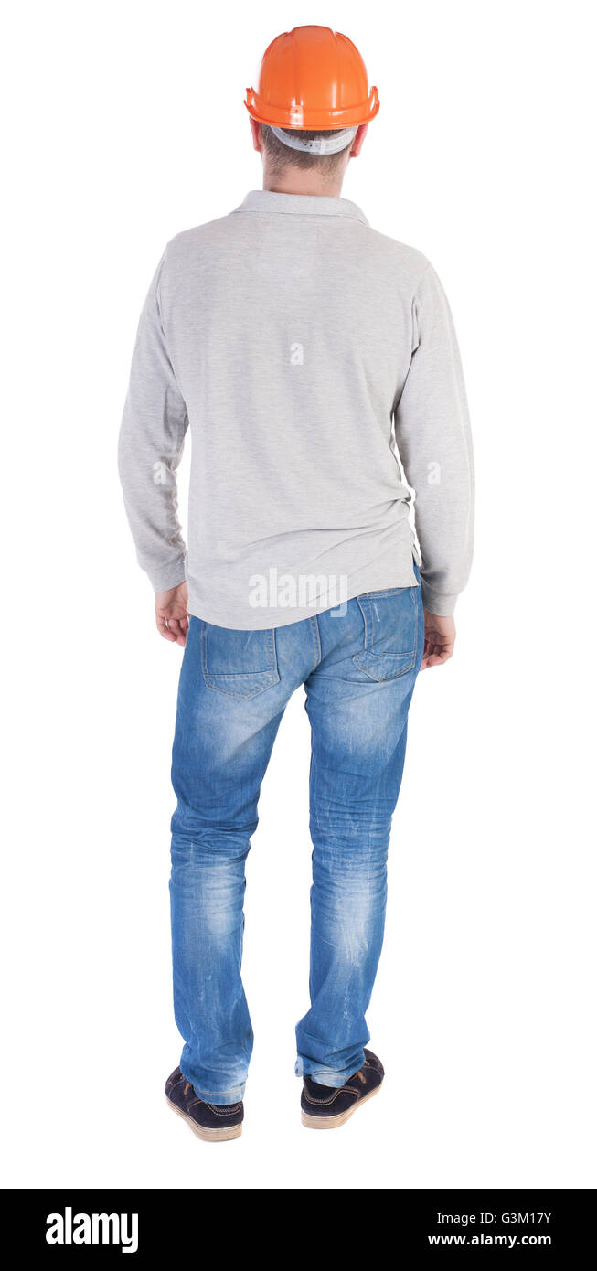 Backview of an engineer in construction helmet stands. Standing young ...