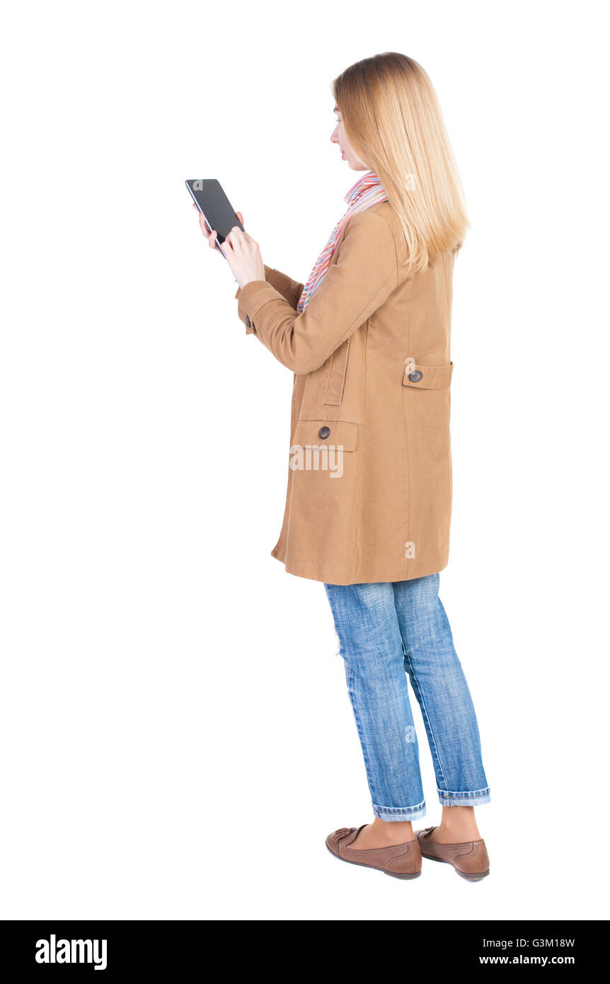 back view of standing young beautiful girl with tablet computer in the ...