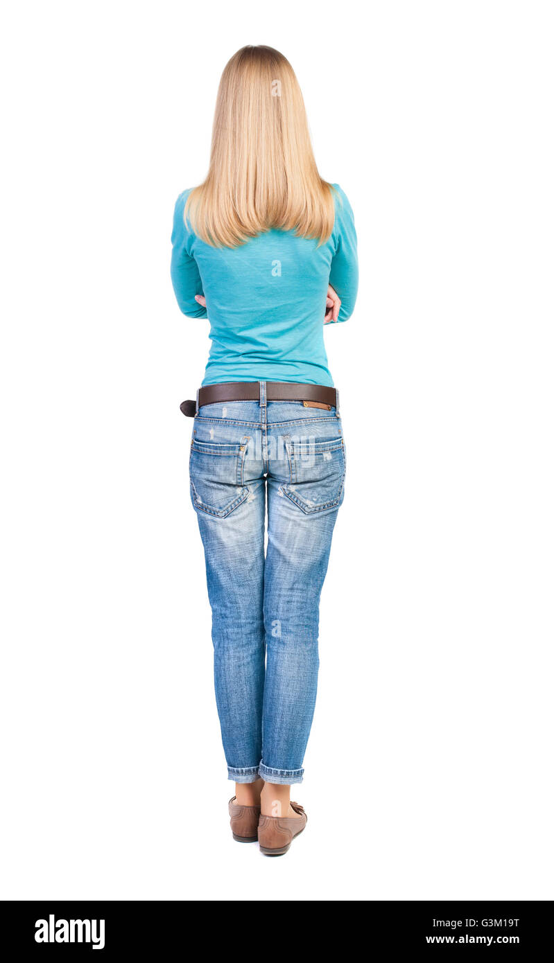 back view of standing young beautiful woman in jeans. girl watching ...