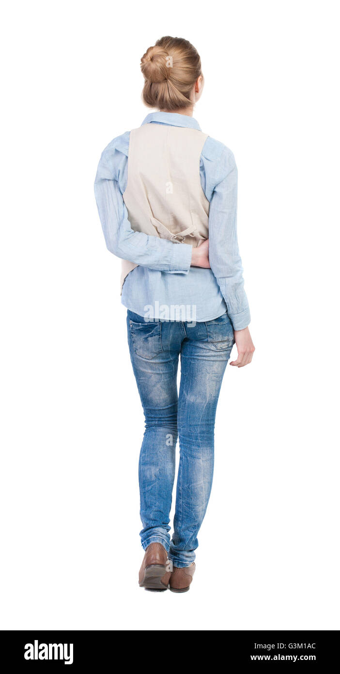 back view of standing young beautiful blonde woman in brown vest. girl ...