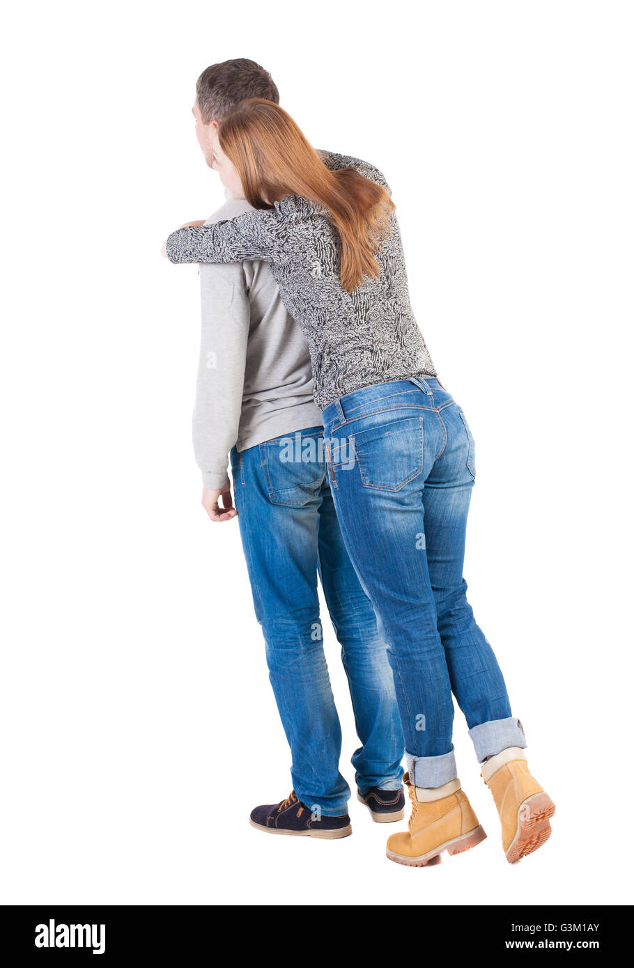 Back view of young embracing couple (man and woman) hug and look into ...