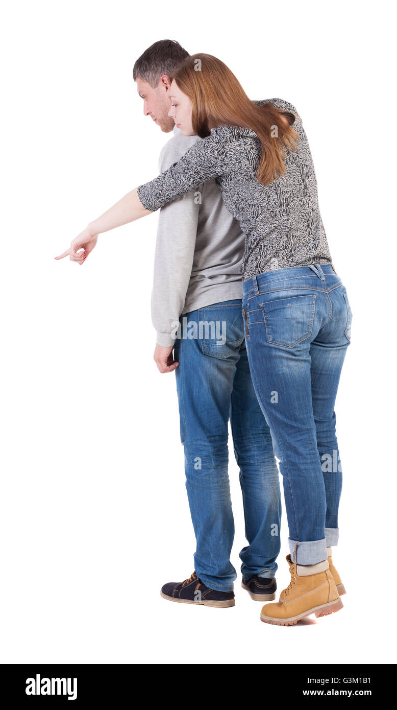 young couple pointing at wal Back view (woman and man). Rear view ...