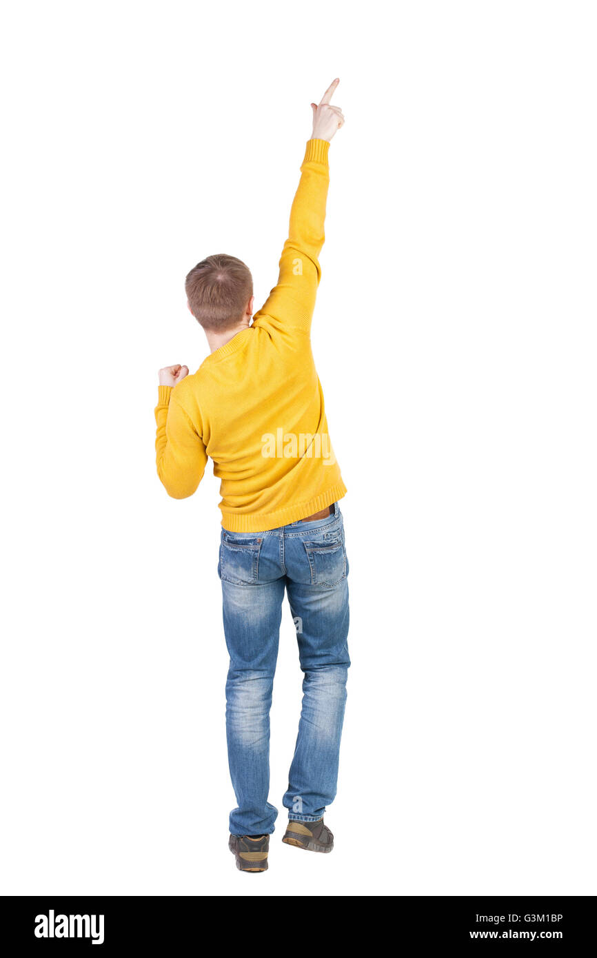 Back view of man. Raised his fist up in victory sign. Rear view people ...