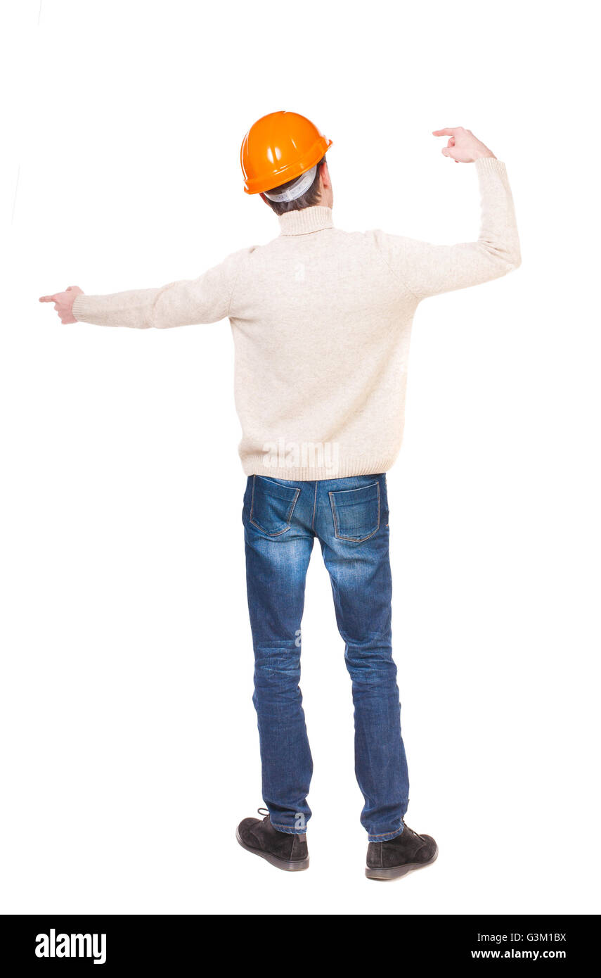 Back view of pointing young men in helmet. Young guy gesture. Rear view ...