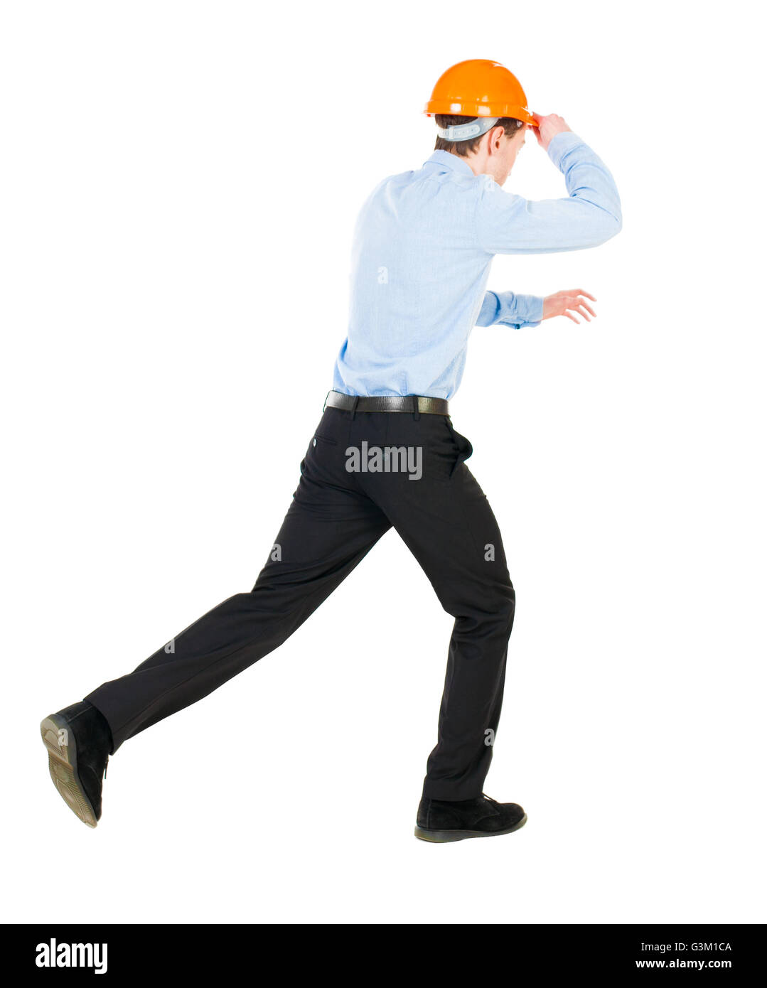 Back view of running engineer in helmet. Walking guy in motion. Rear ...