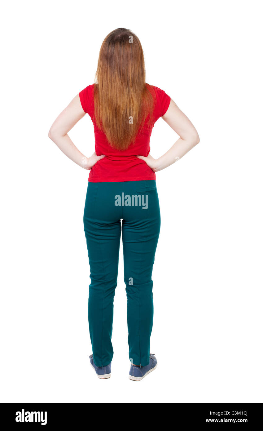 back view of standing young beautiful woman in jeans. girl watching ...