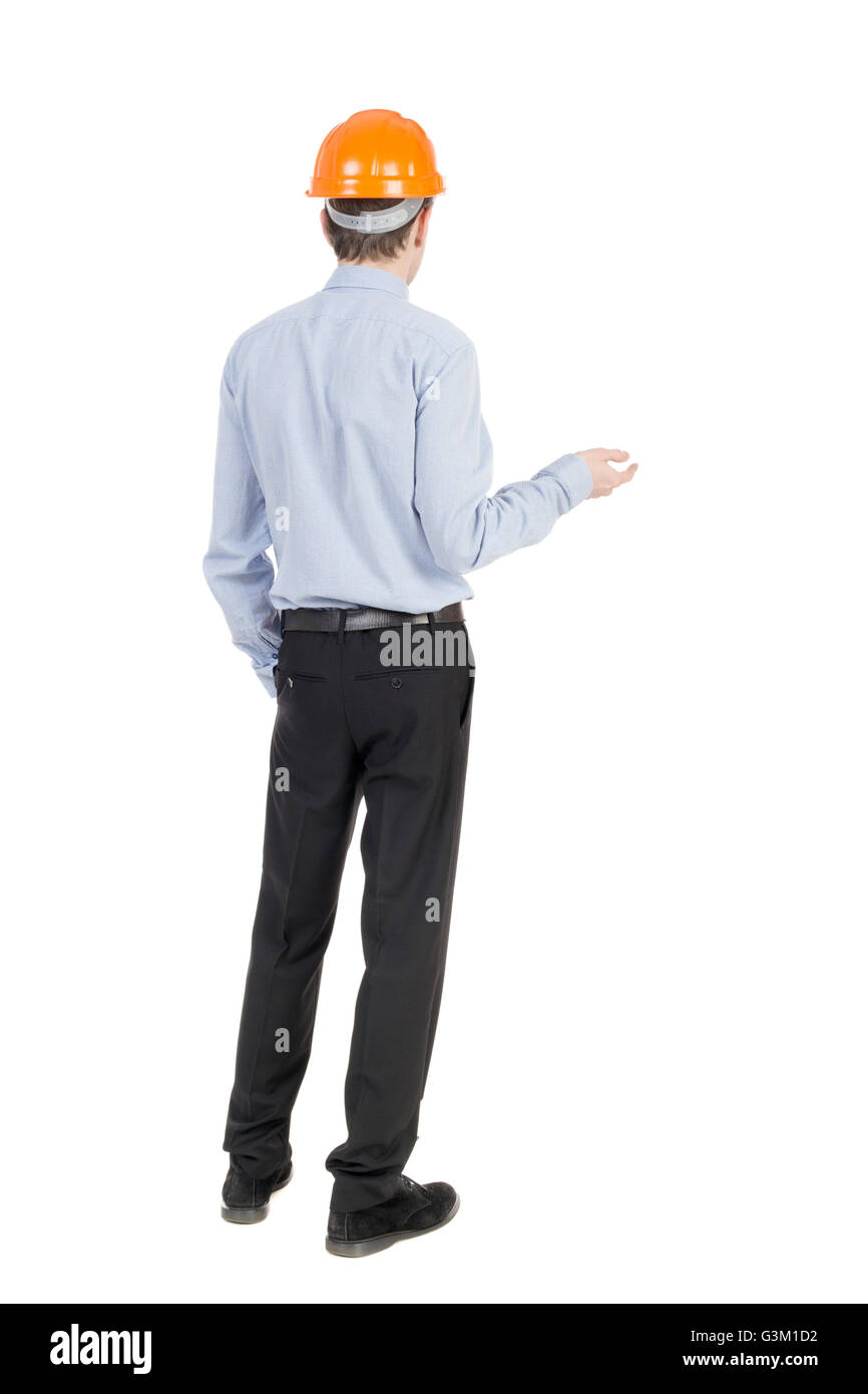 Backview of an engineer in construction helmet stands. Standing young ...
