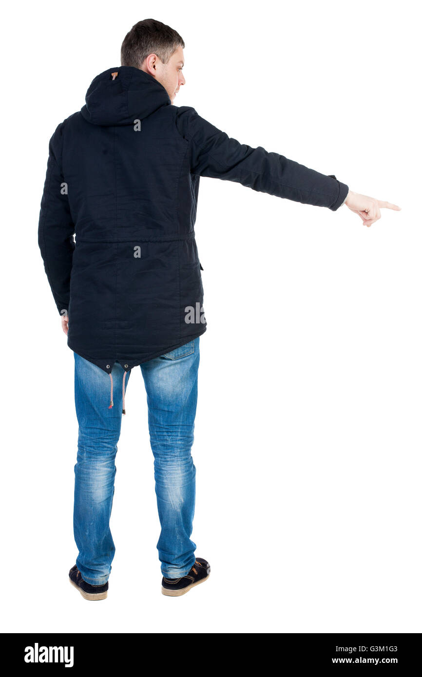 Back view of pointing man in winter jacket looking up. Standing young ...