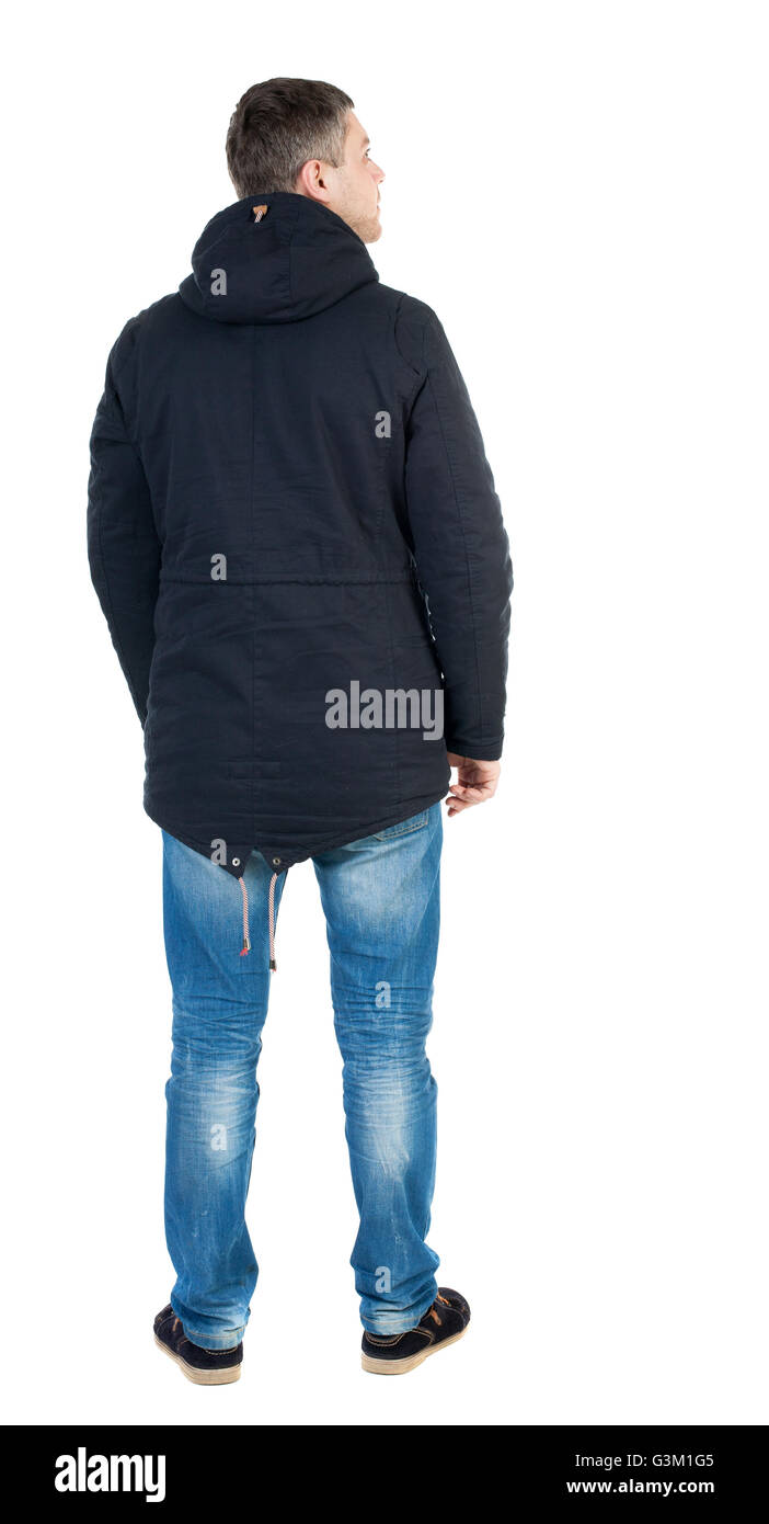 Back view of handsome man in winter jacket looking up. Standing young ...