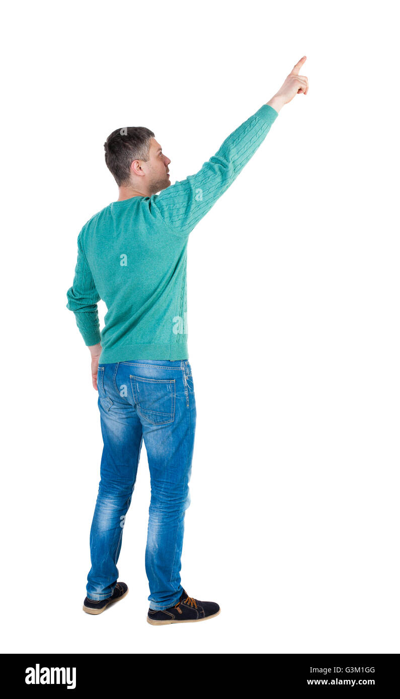Back view of pointing young men in jeans. Young guy gesture. Rear view ...