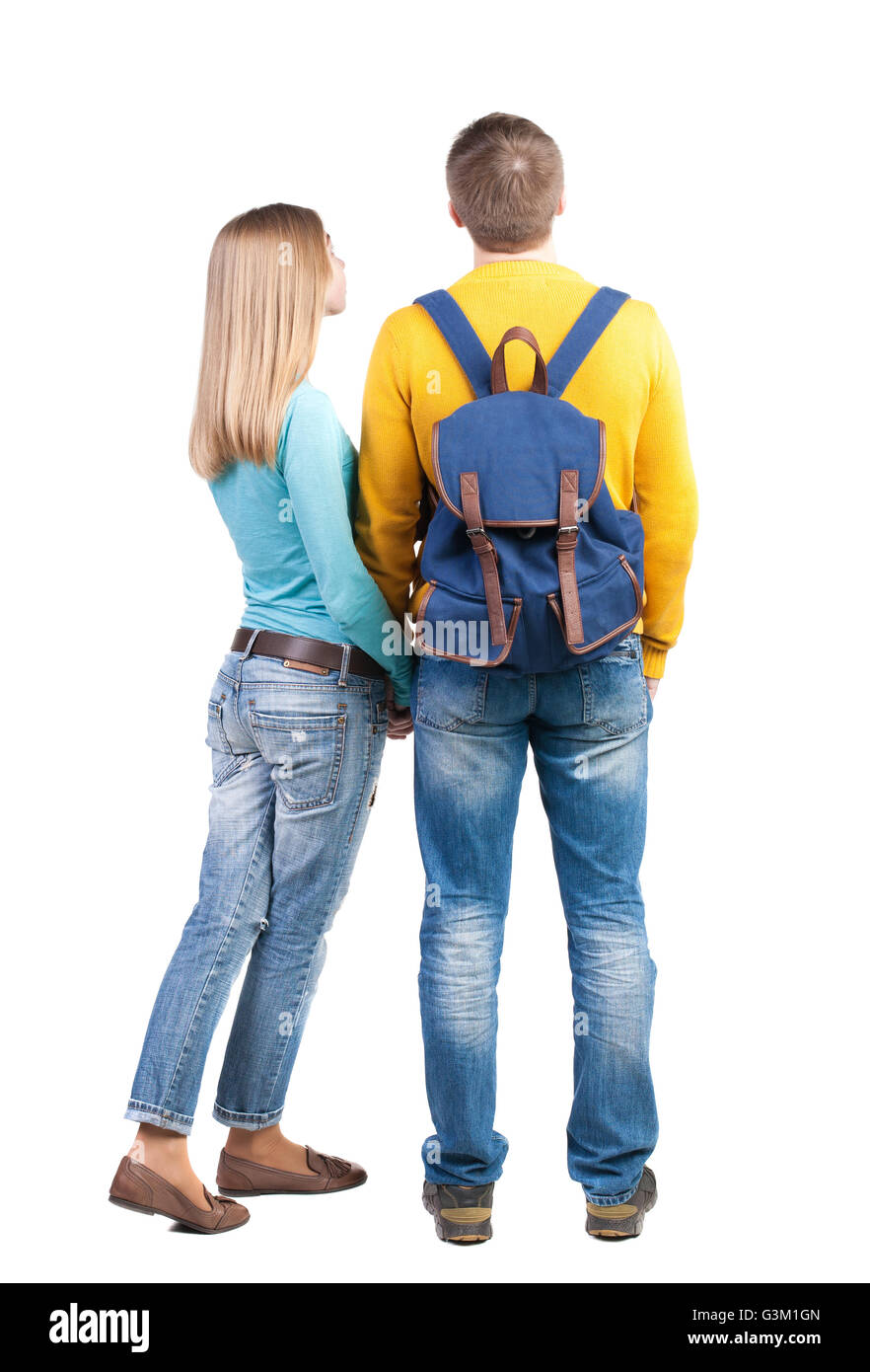 Back view of young embracing couple (man and woman) hug and look into ...
