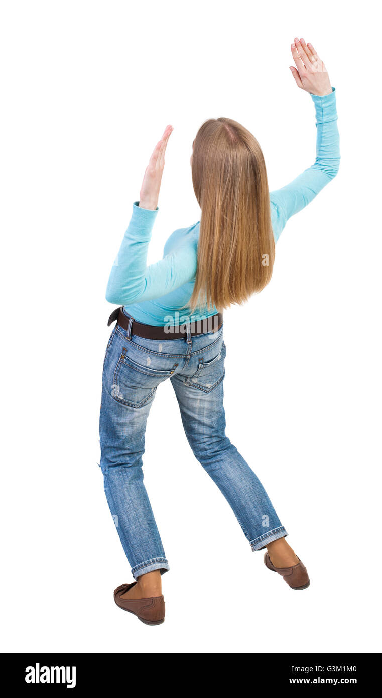 Balancing young woman. or dodge falling woman. Rear view people ...