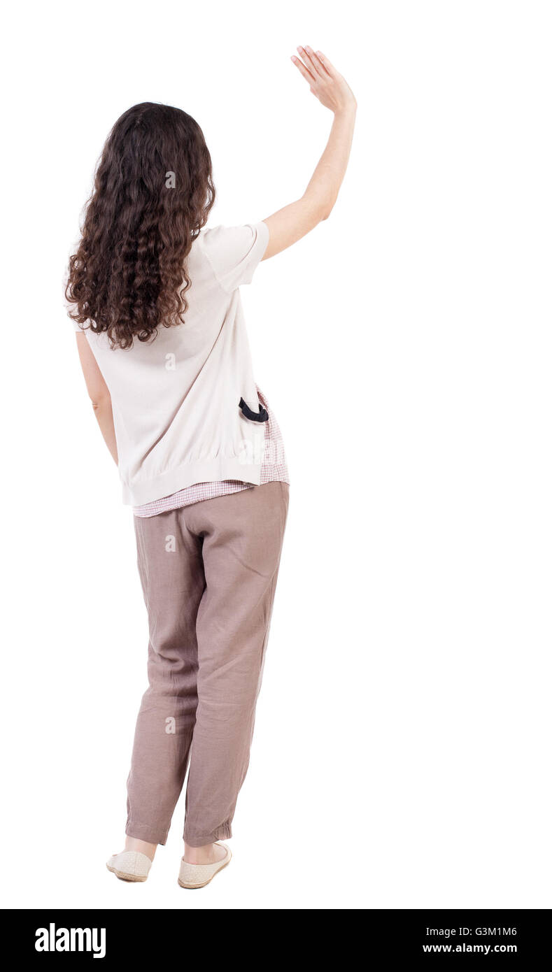 Back view of curly woman welcomes. Young teenager girl hand waving from ...