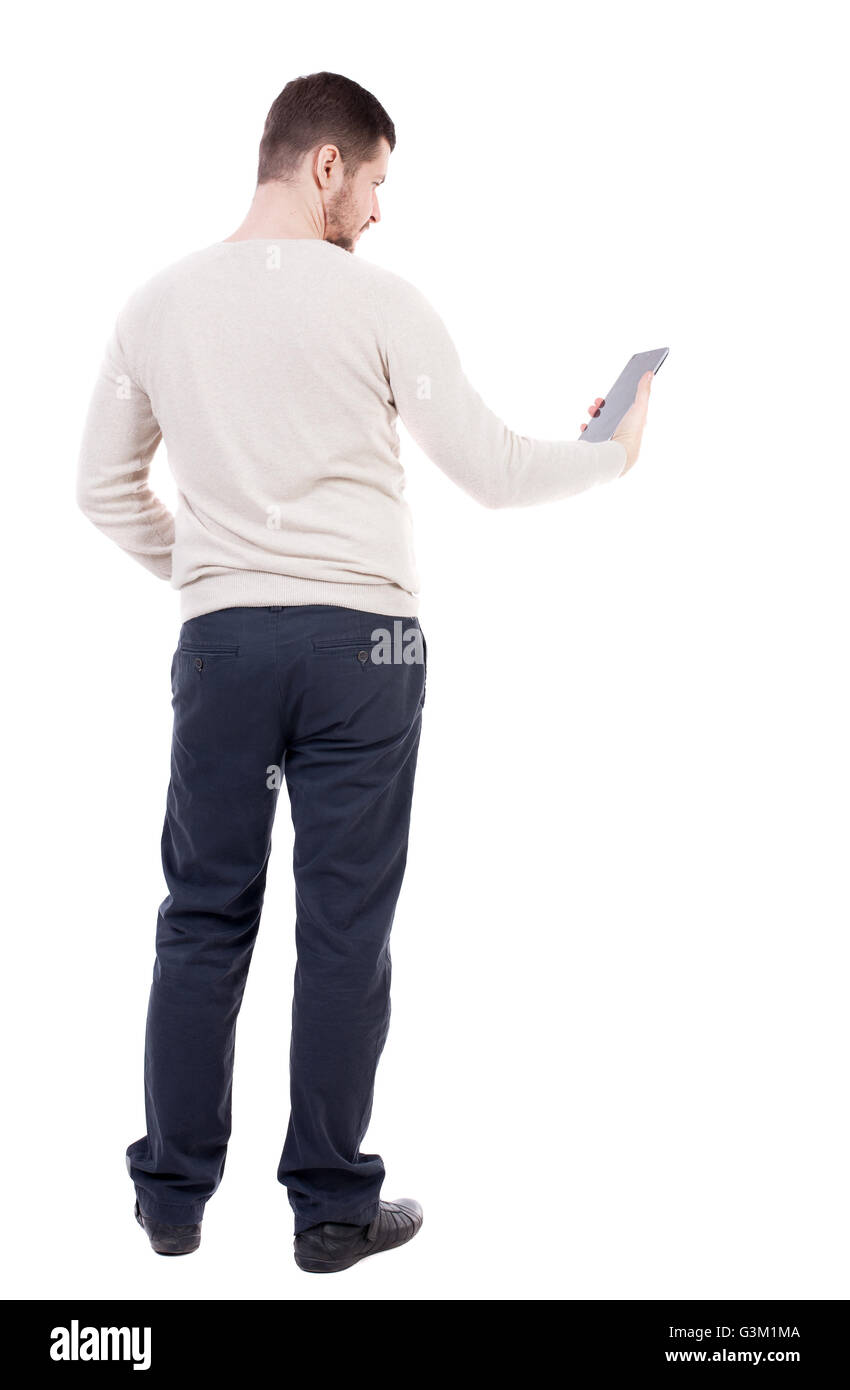 back view of standing young man with tablet computer in the hands of ...