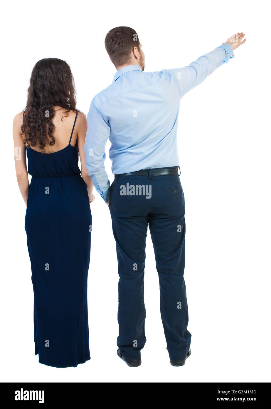young couple pointing at wal Back view (woman and man). Rear view ...