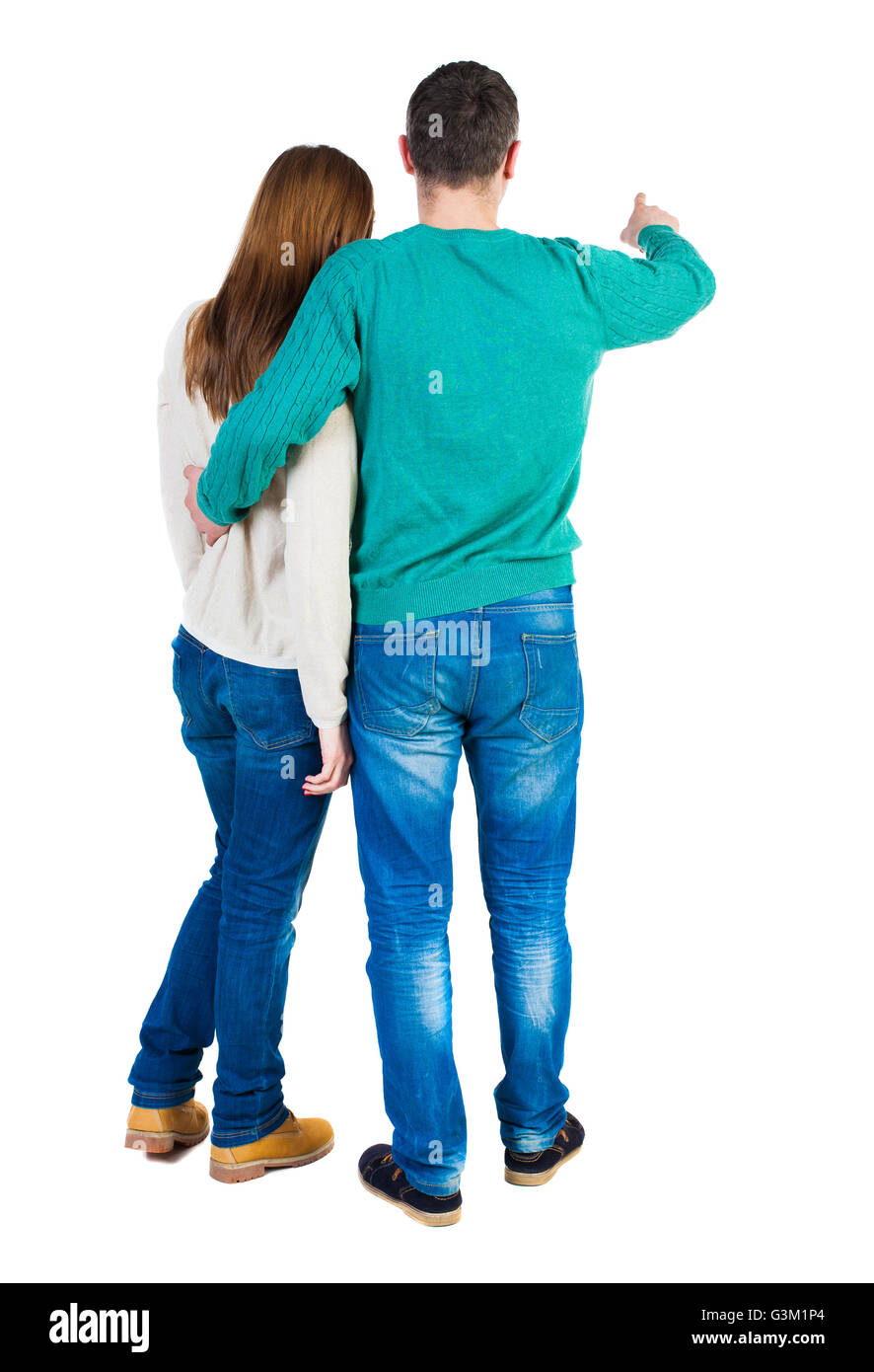 young couple pointing at wal Back view (woman and man). Rear view ...