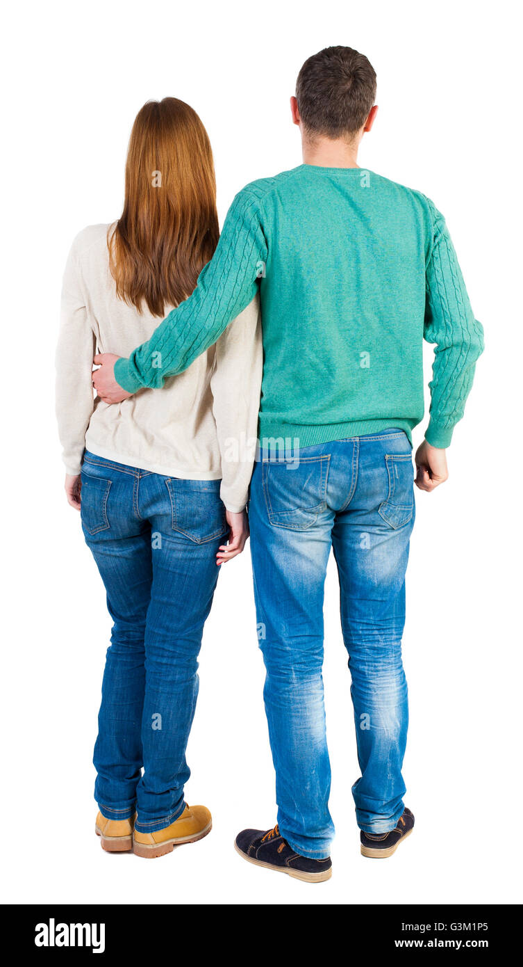 Back view of young embracing couple (man and woman) hug and look into ...