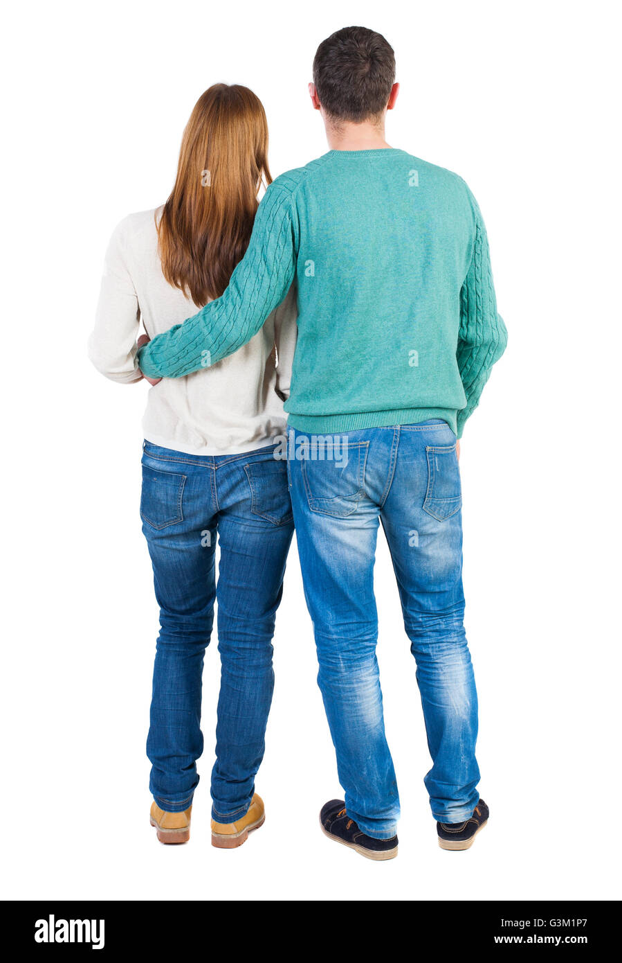 Back view of young embracing couple (man and woman) hug and look into ...