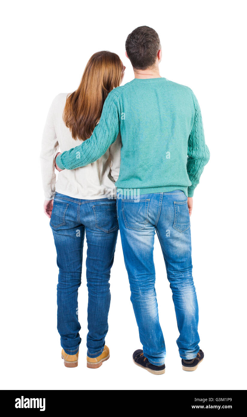 Back view of young embracing couple (man and woman) hug and look into ...