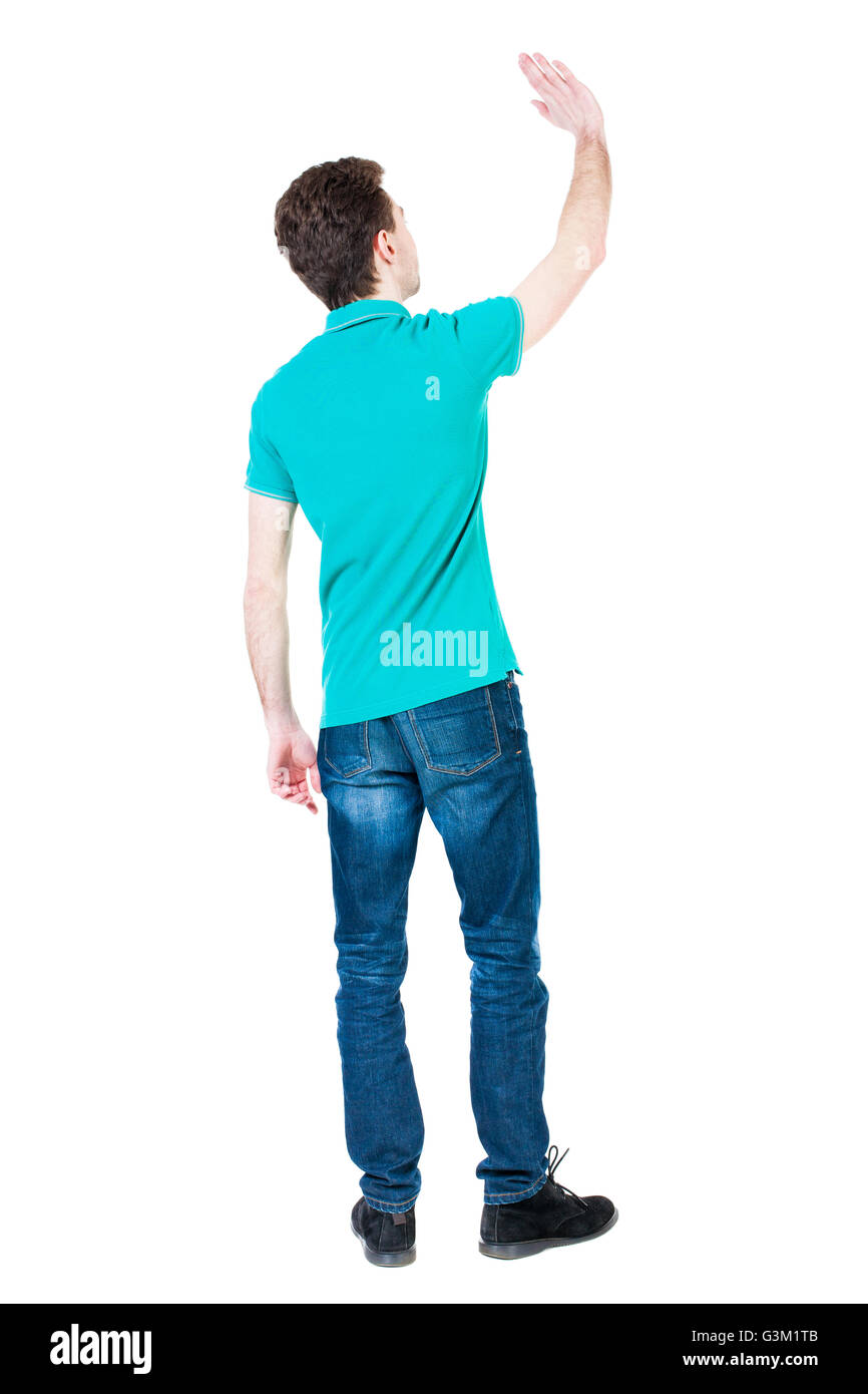 Back view of handsome man greeting waving from his hands. Standing ...