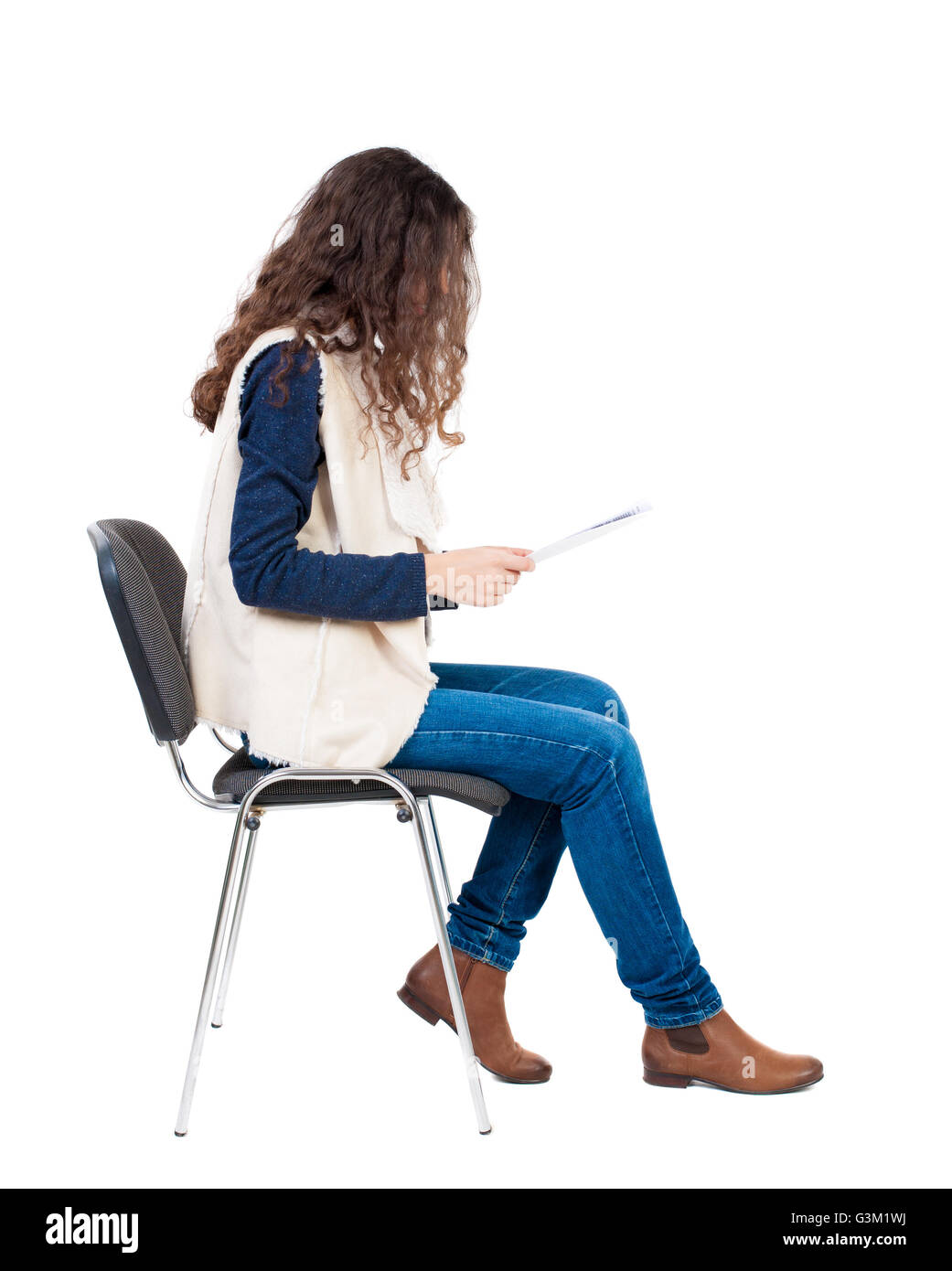 back view of young beautiful woman sitting on chair. girl watching ...