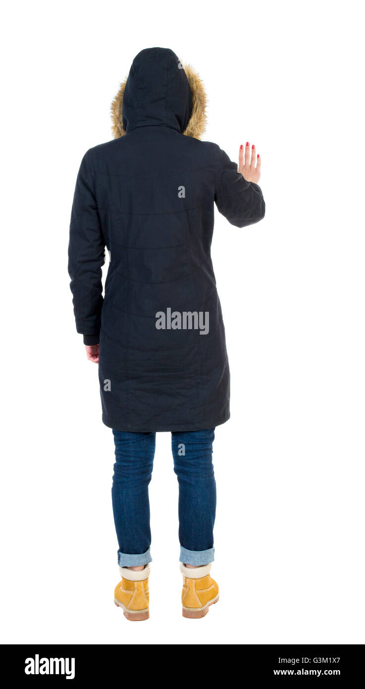 Back view of pointing young women in parka. Young girl gesture. Rear ...