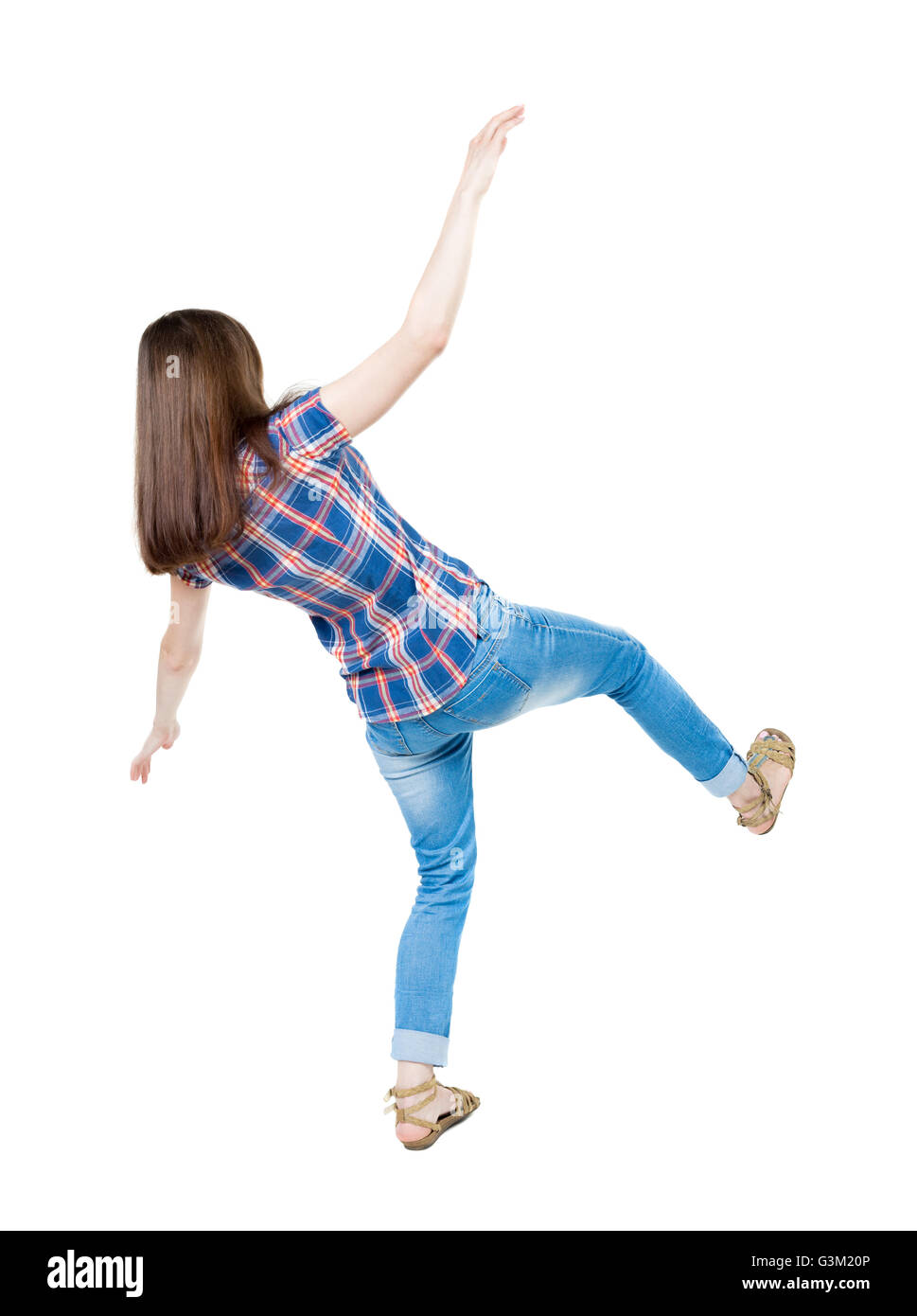 Back view woman Balances waving his arms. Standing young girl in jeans ...
