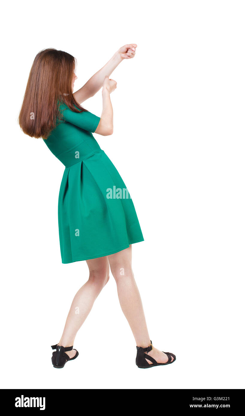 back view of standing girl pulling a rope from the top or cling to ...