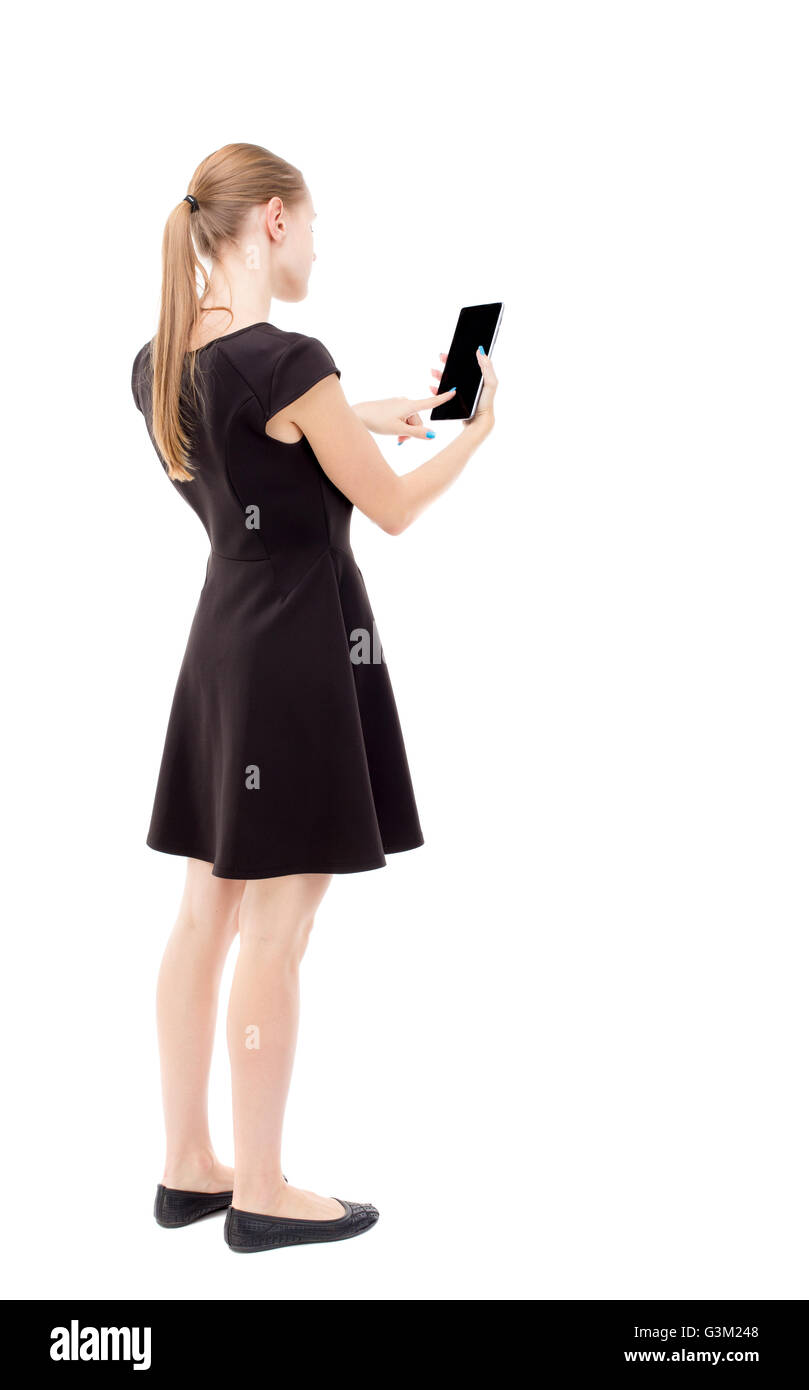 back view of standing young beautiful girl with tablet computer in the ...