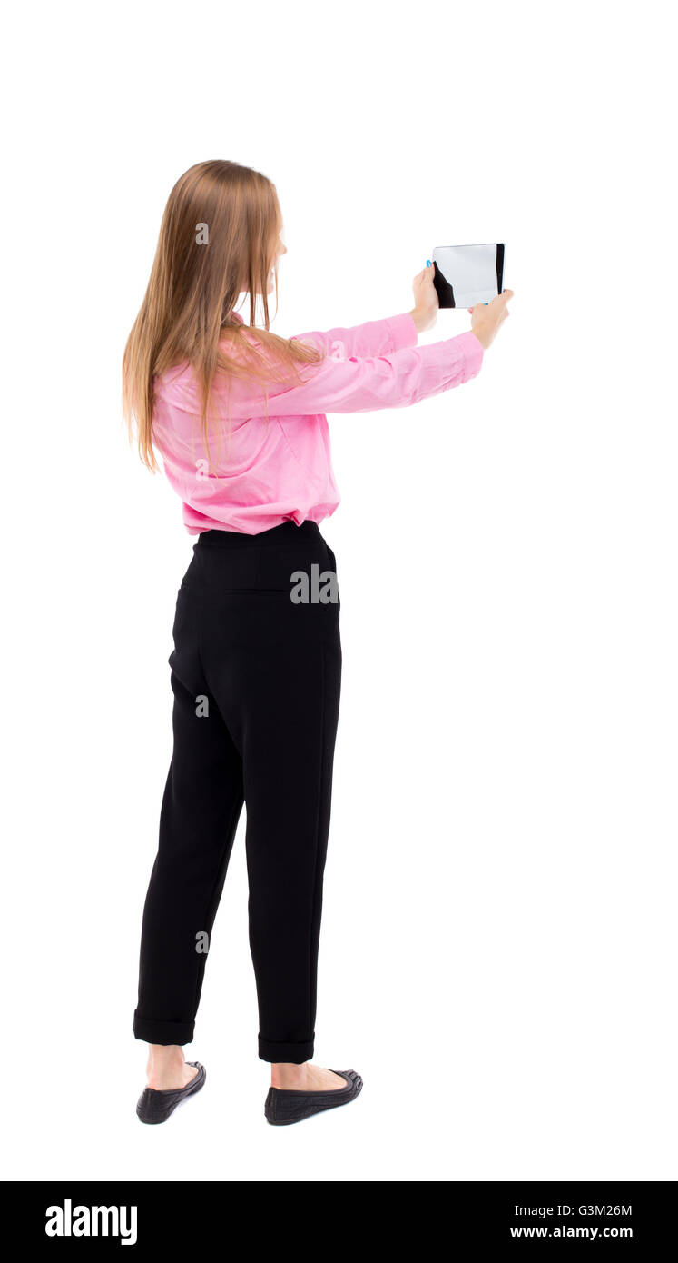 back view of standing young beautiful girl with tablet computer in the ...