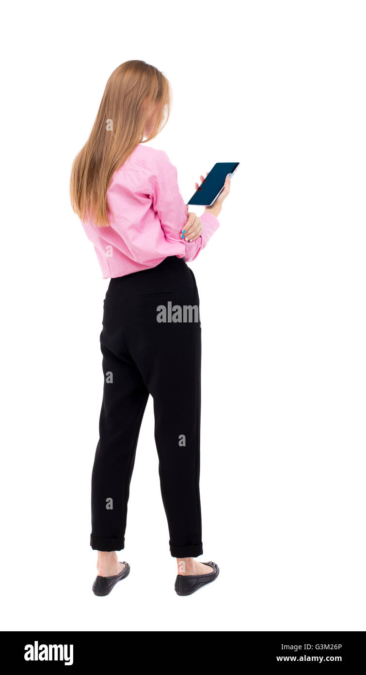 back view of standing young beautiful girl with tablet computer in the ...