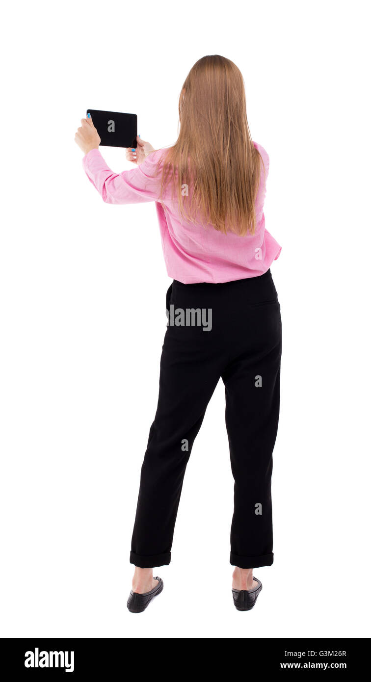 back view of standing young beautiful girl with tablet computer in the ...