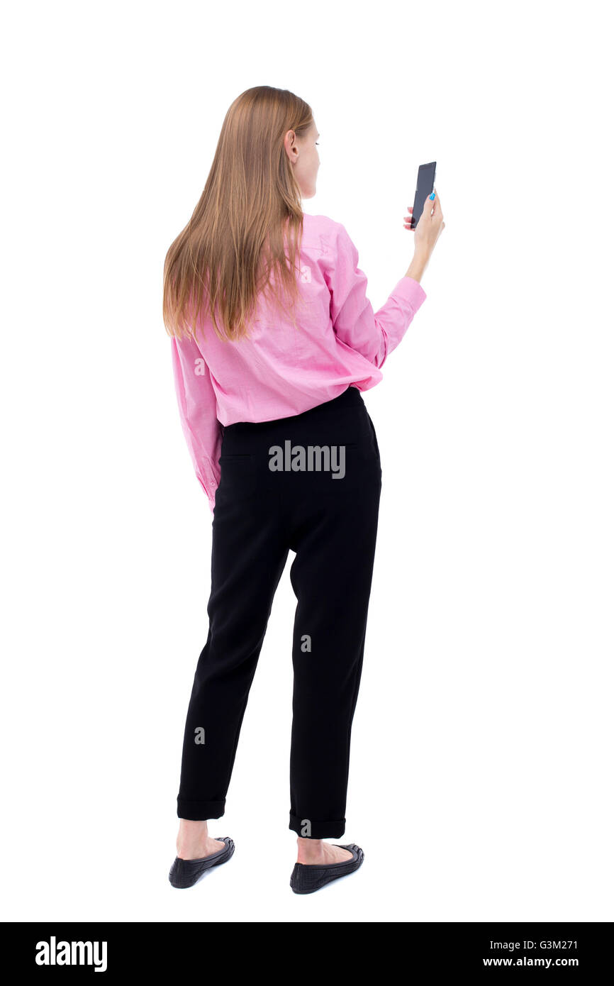 back view of standing young beautiful woman and using a mobile phone ...