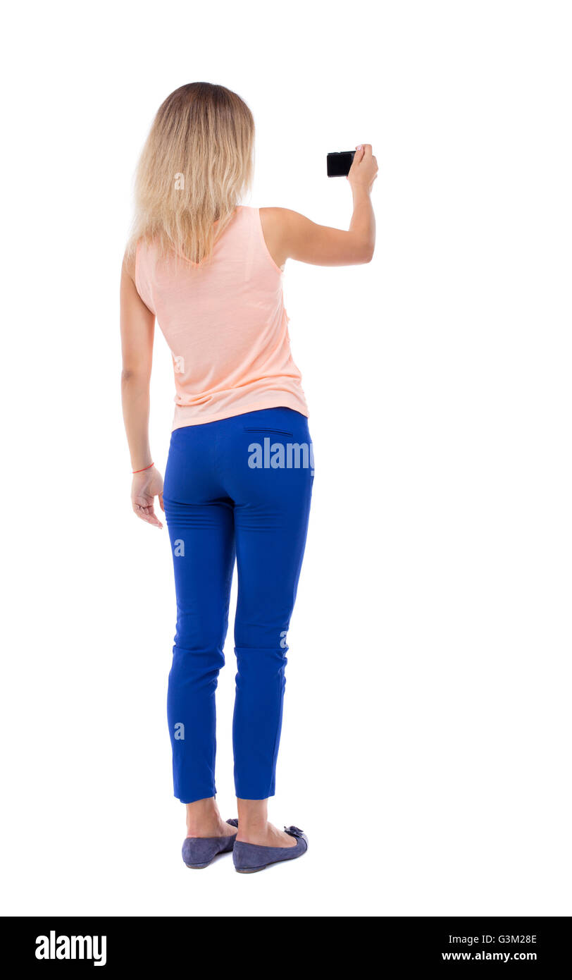 back view of standing young beautiful woman and using a mobile phone ...