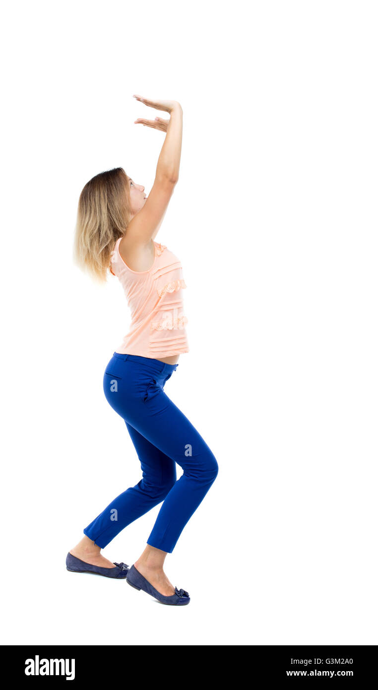 back view of woman protects hands from what is falling from above ...