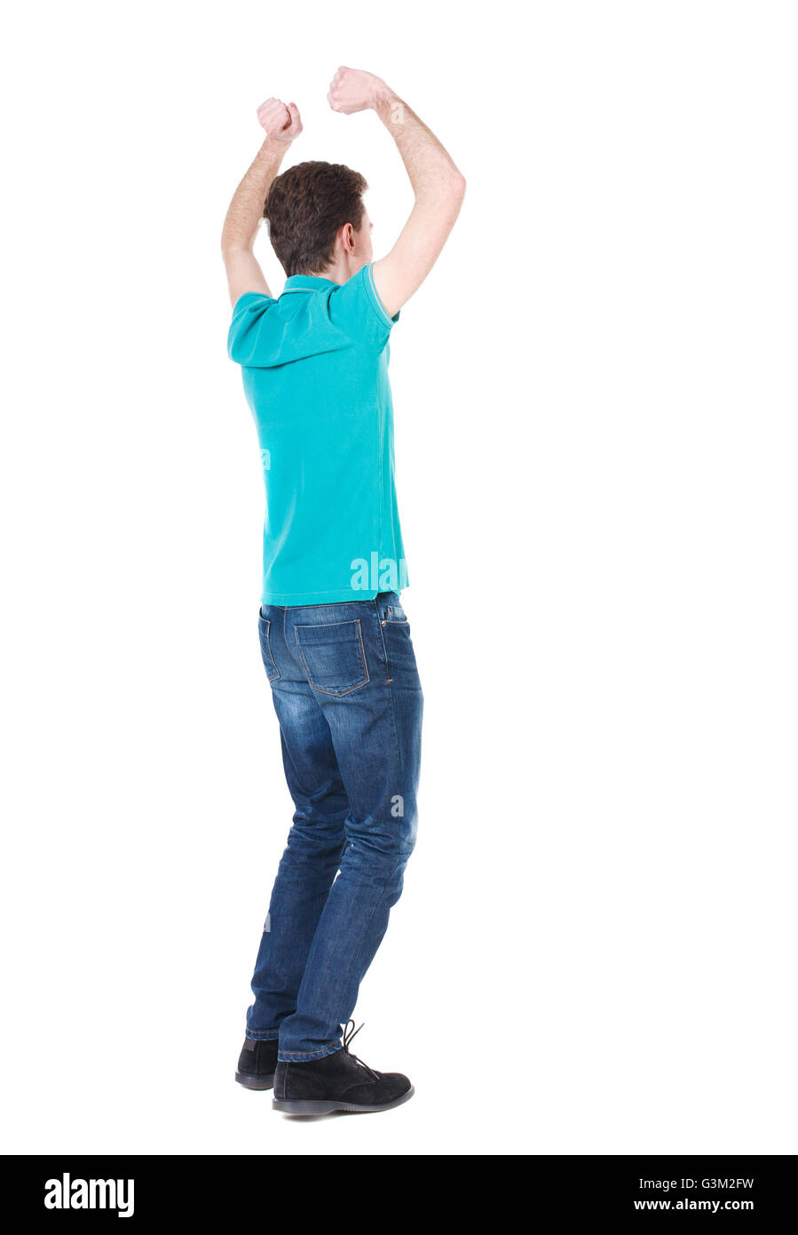 Back view of man. Raised his fist up in victory sign. Rear view people ...