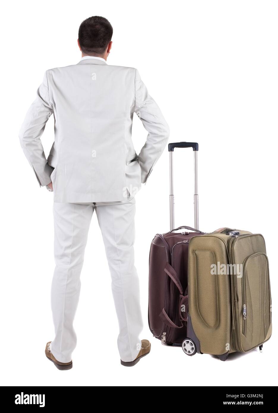 Back view of traveling busness man with suitcase looking up. Standing ...