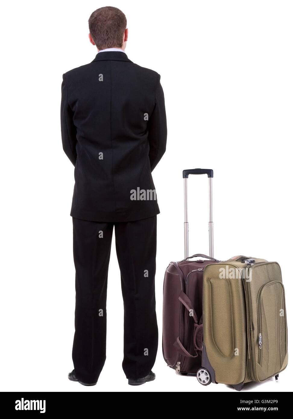 Back view of traveling busness man with suitcase looking up. Standing ...