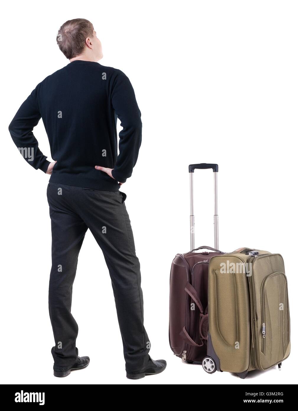 Back view of traveling busness man with suitcase looking up. Standing ...