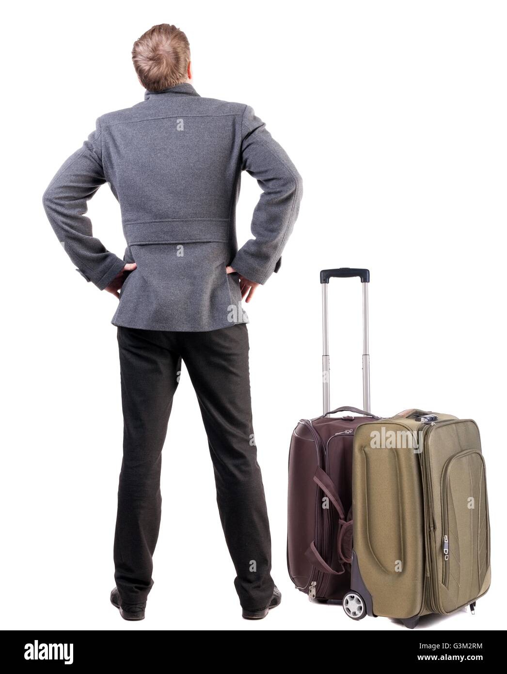 Back view of traveling busness man with suitcase looking up. Standing ...